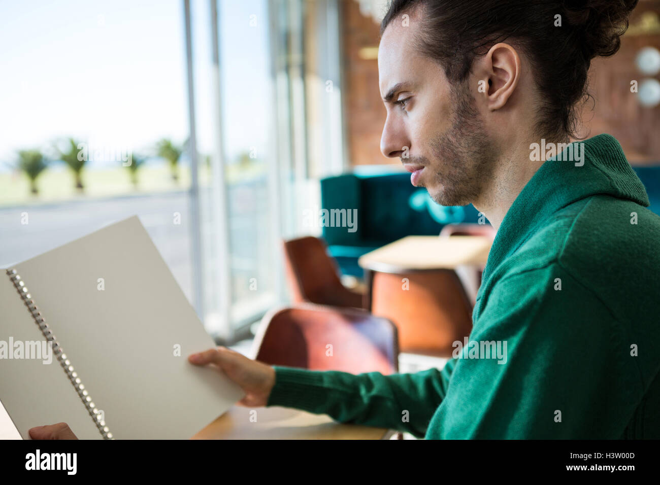 Man looking at menu Stock Photo - Alamy