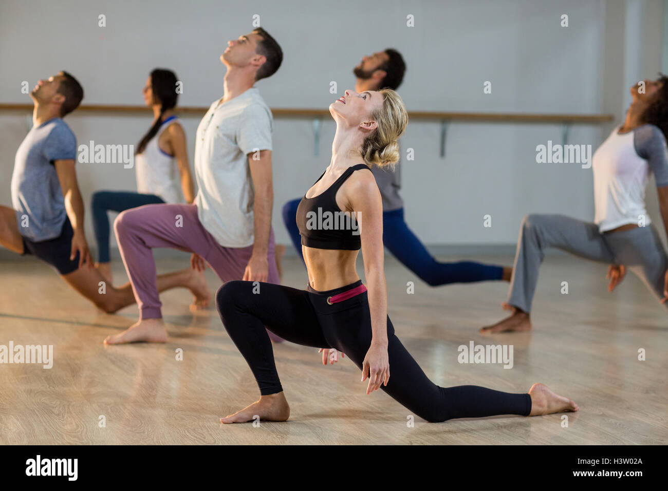 Group of people performing stretching exercise Stock Photo - Alamy