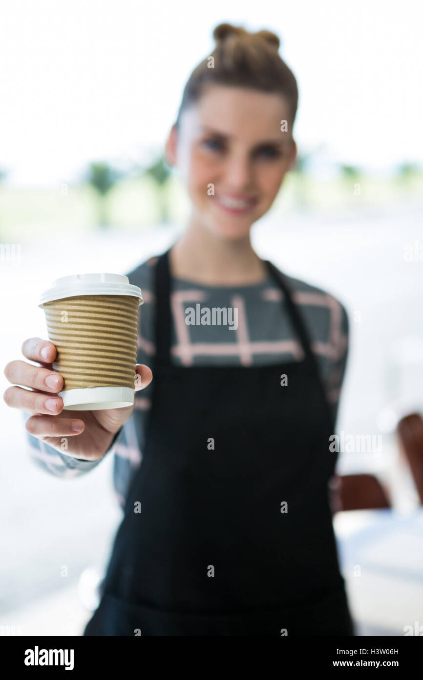 Portrait of smiling waitress offering coffee Stock Photo - Alamy