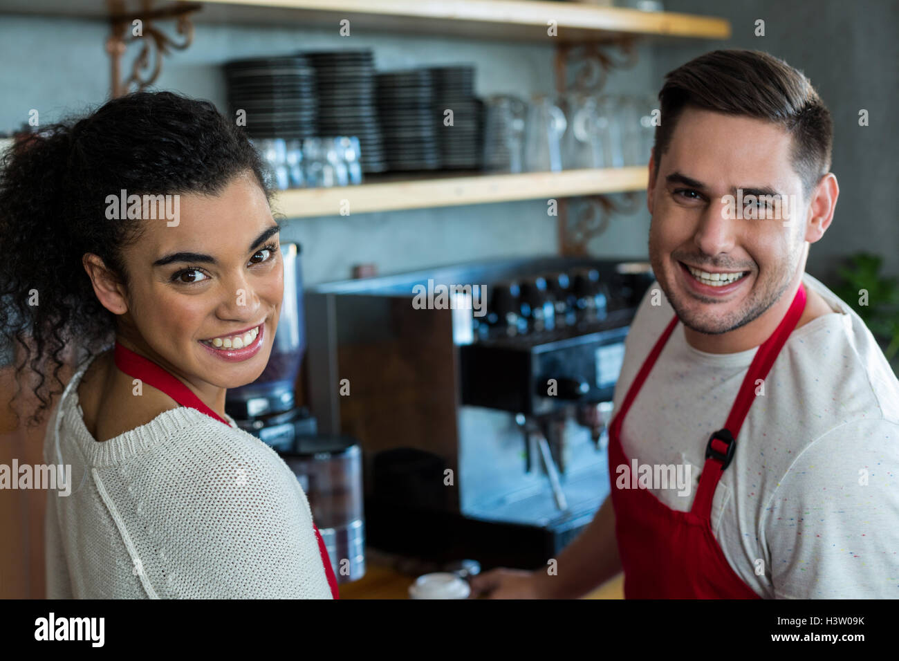 Smiling waitress and waiter in cafe Stock Photo - Alamy