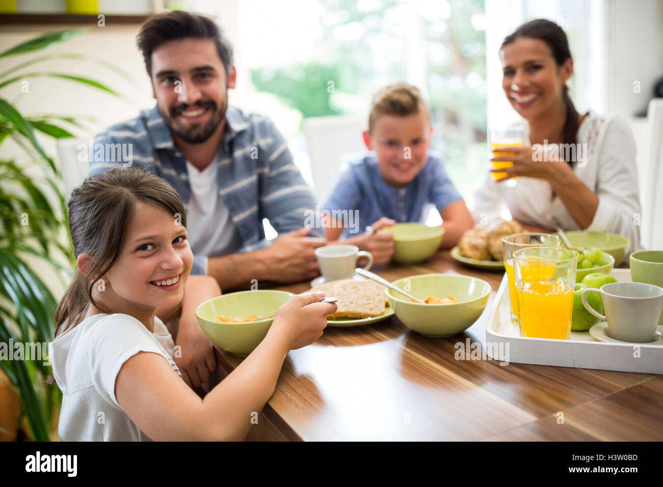 Portrait of family having breakfast Stock Photo - Alamy