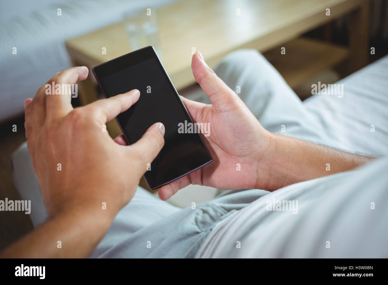 Mid section of man checking his mobile phone Stock Photo - Alamy