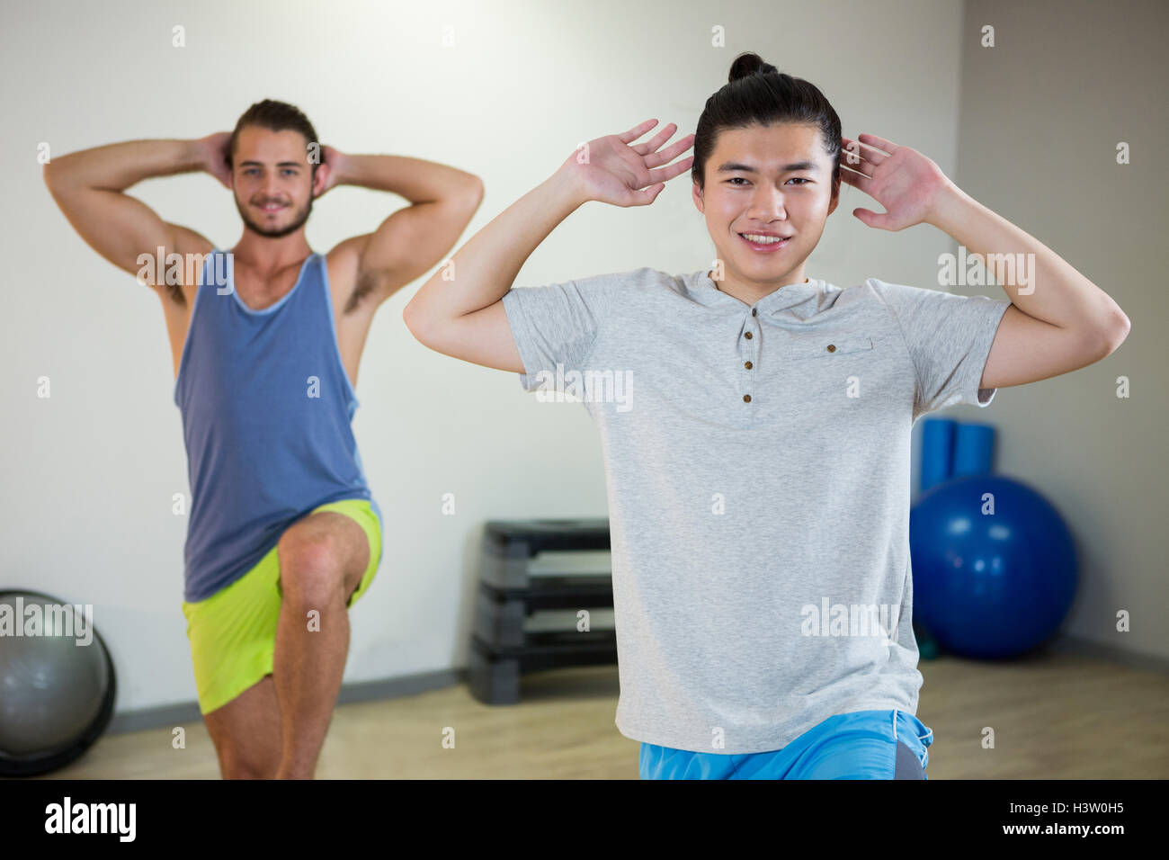 Smiling two men doing aerobic exercise Stock Photo - Alamy