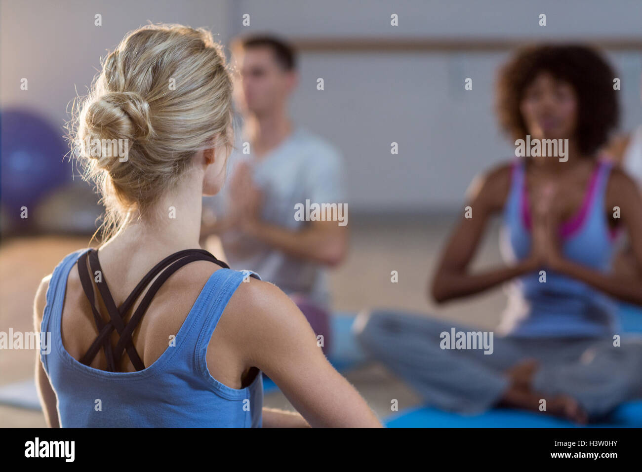 Instructor taking yoga class Stock Photo - Alamy