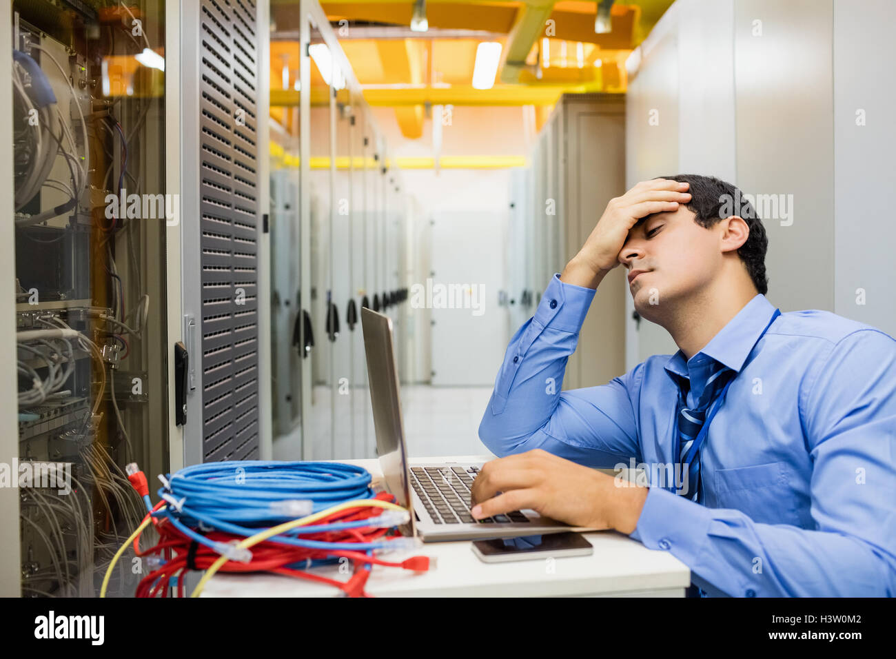 Stressed technician working laptop Stock Photo - Alamy