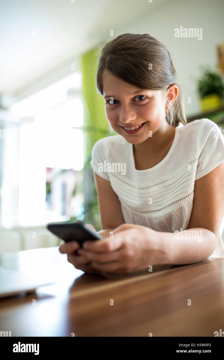 Girl using mobile phone in the living room Stock Photo - Alamy