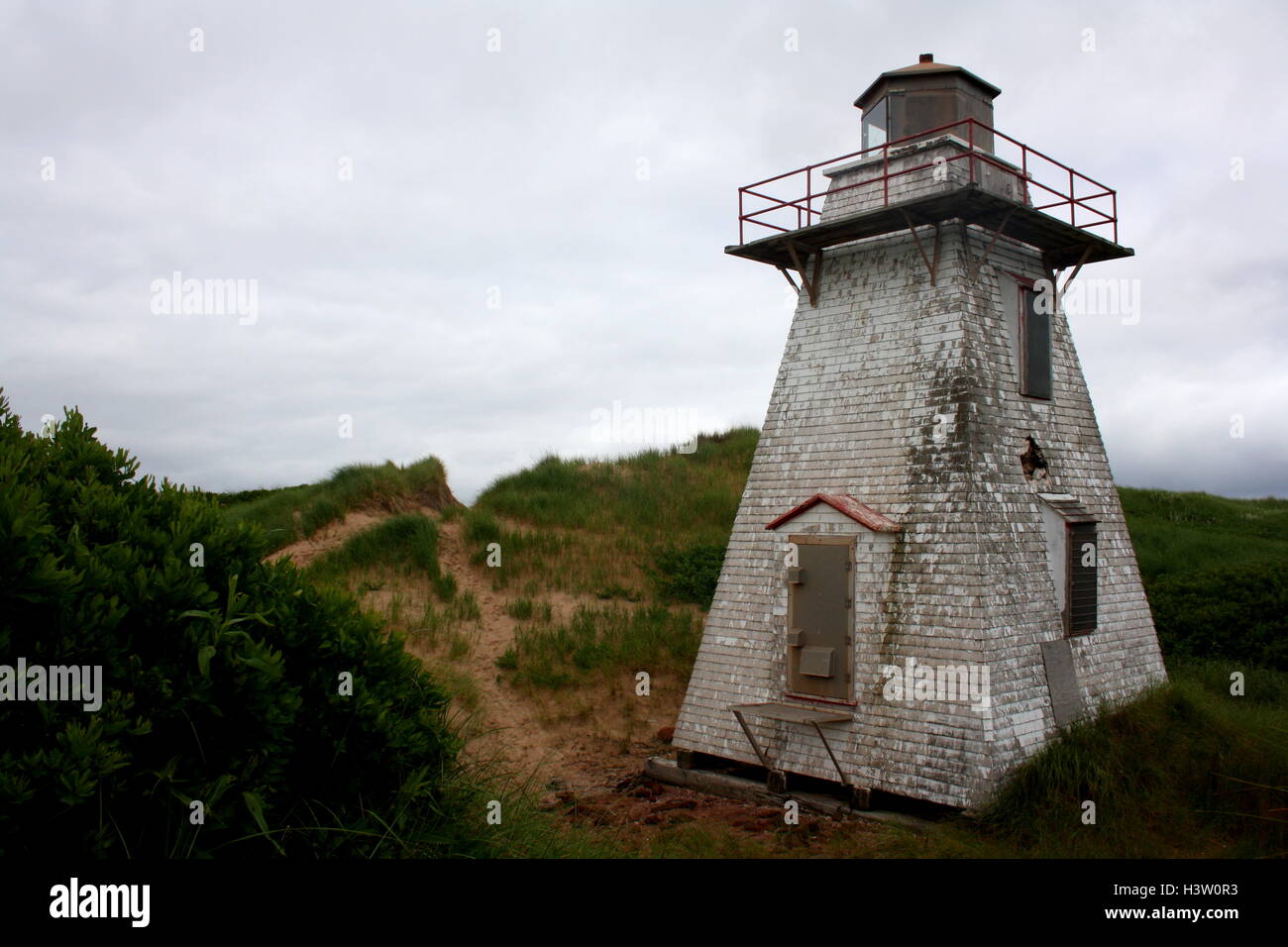 Abandoned lighthouse hidden among the dunes Stock Photo - Alamy