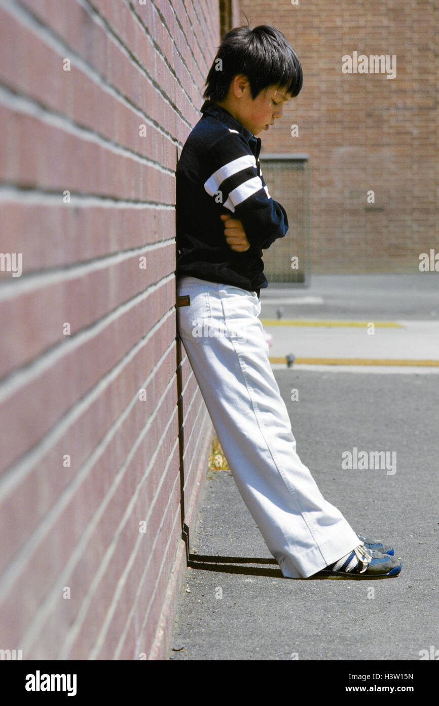 Child standing alone in playground hi-res stock photography and images ...