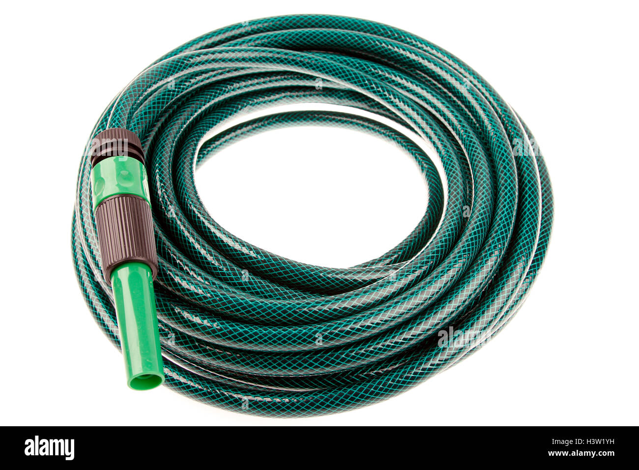Garden hose coiled on plain background Stock Photo - Alamy