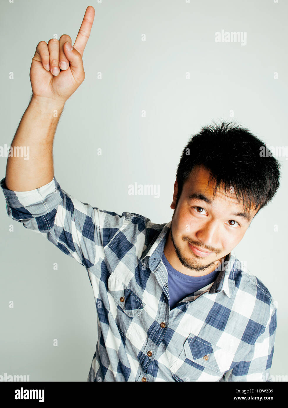 young cute asian man on white background gesturing emotional, pointing ...
