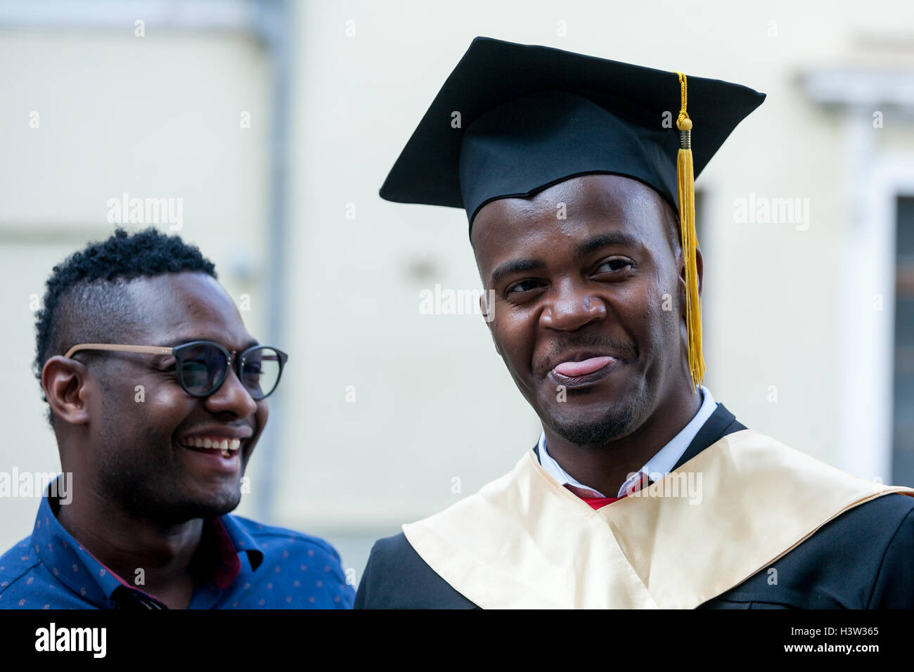 Graduate students wearing graduation hat and gown Stock Photo - Alamy