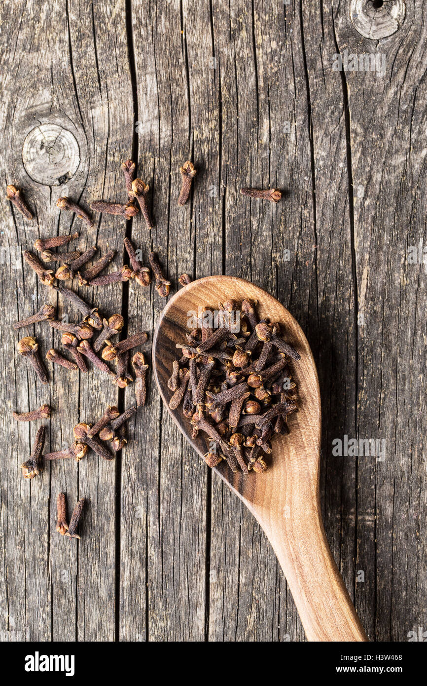 The clove spice in wooden spoon. Top view Stock Photo - Alamy
