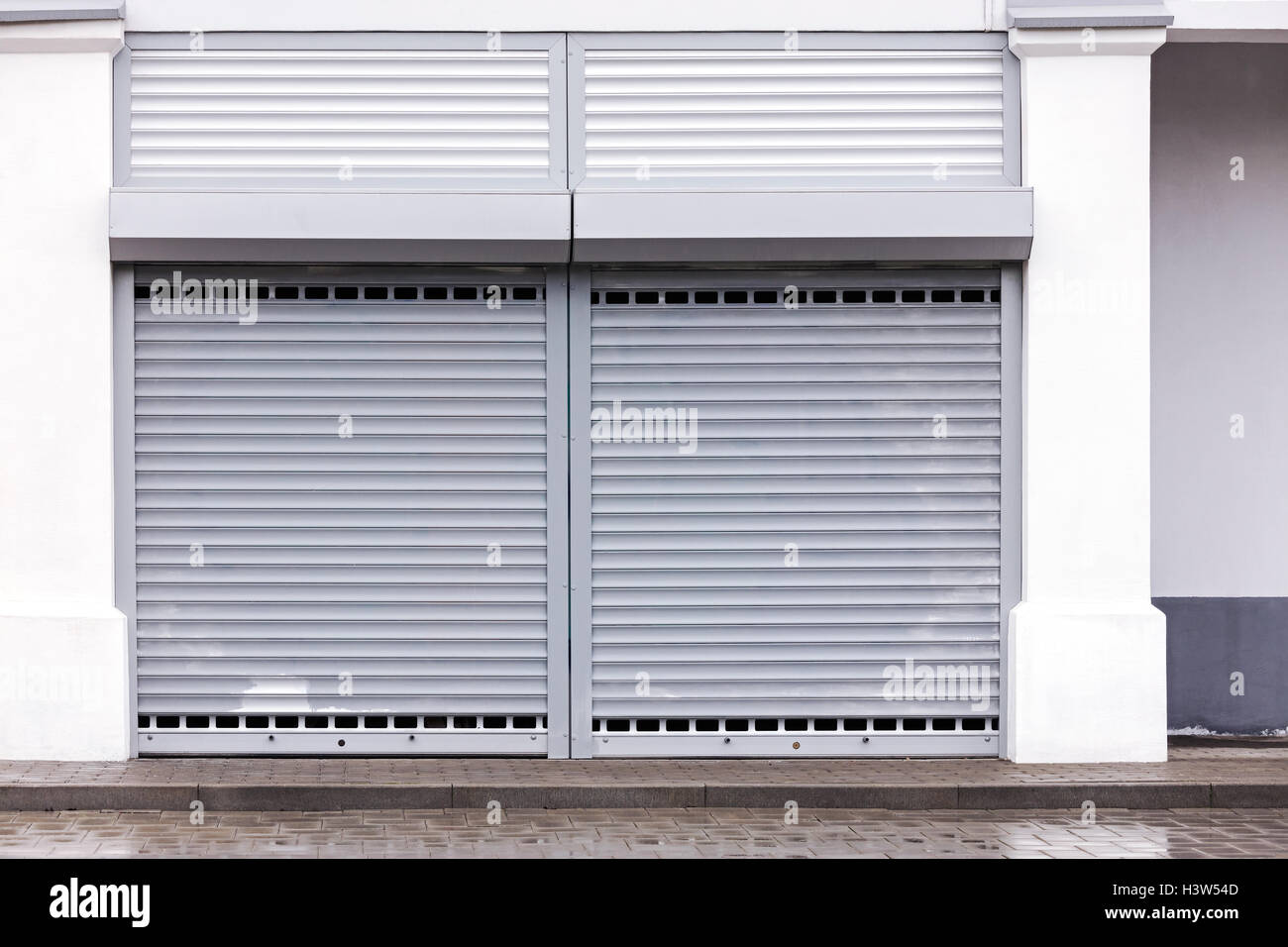 warehouse facade wall with grey corrugated metal gate Stock Photo - Alamy