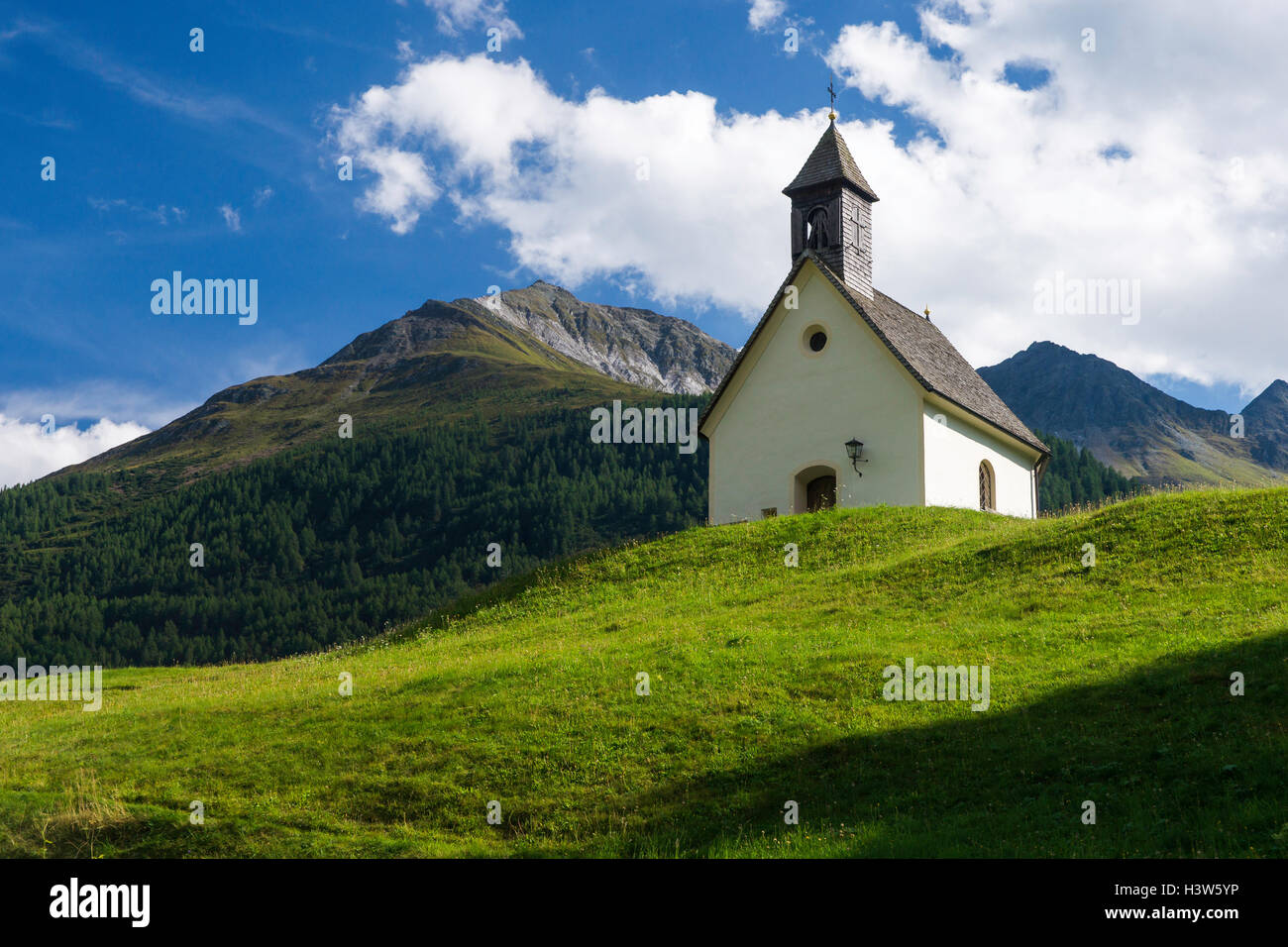 A small chapel on a hill in the austrian alps Stock Photo - Alamy