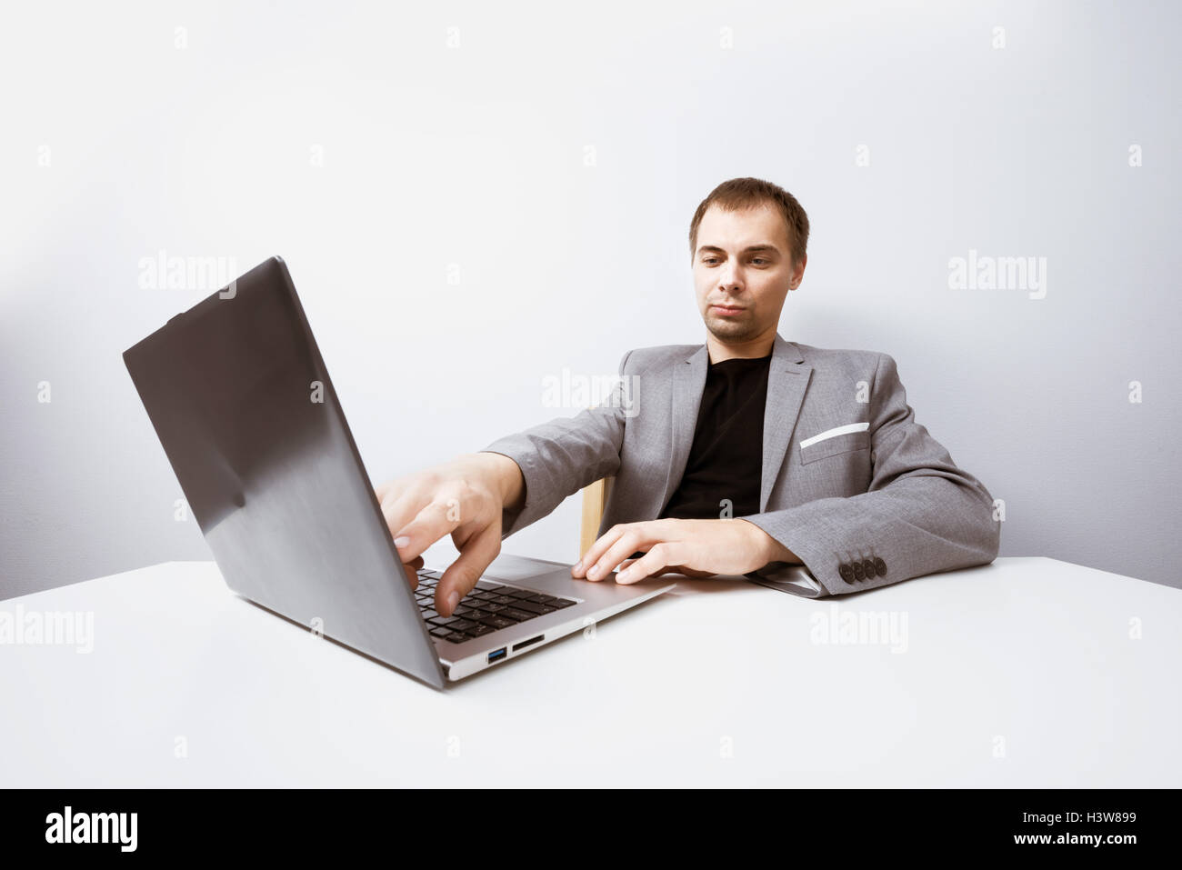 Handsome businessman working with laptop in office Stock Photo - Alamy