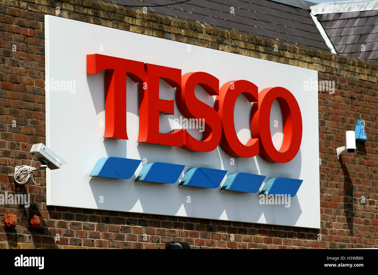 Tesco store logo attached to brick wall, Grove Shopping Centre, Witham ...
