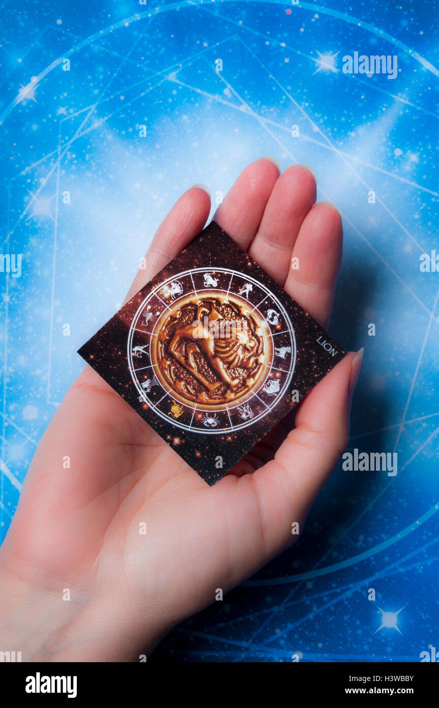 hand holding a card with zodiac sign of Leo Stock Photo - Alamy
