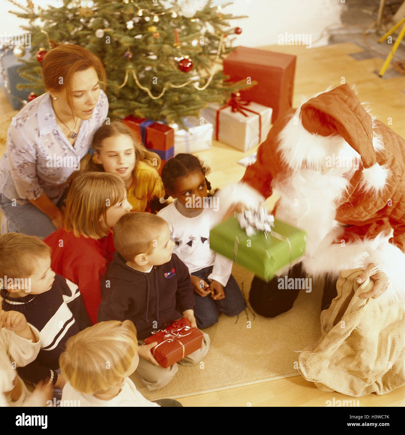 Santa Claus, pouch, children, woman, distribution presents inside, at ...