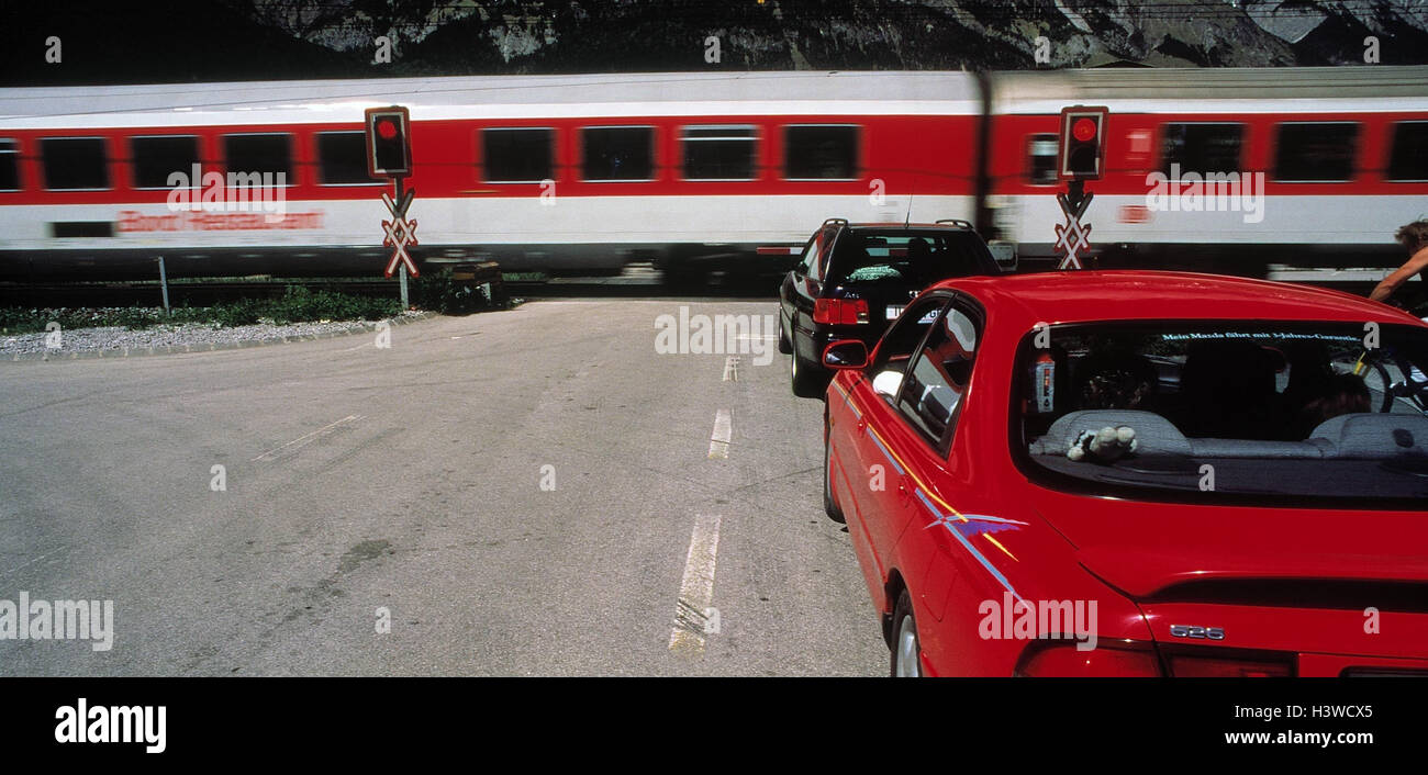 Passenger car, two, wait, drive gates, closed, train, drive past ...