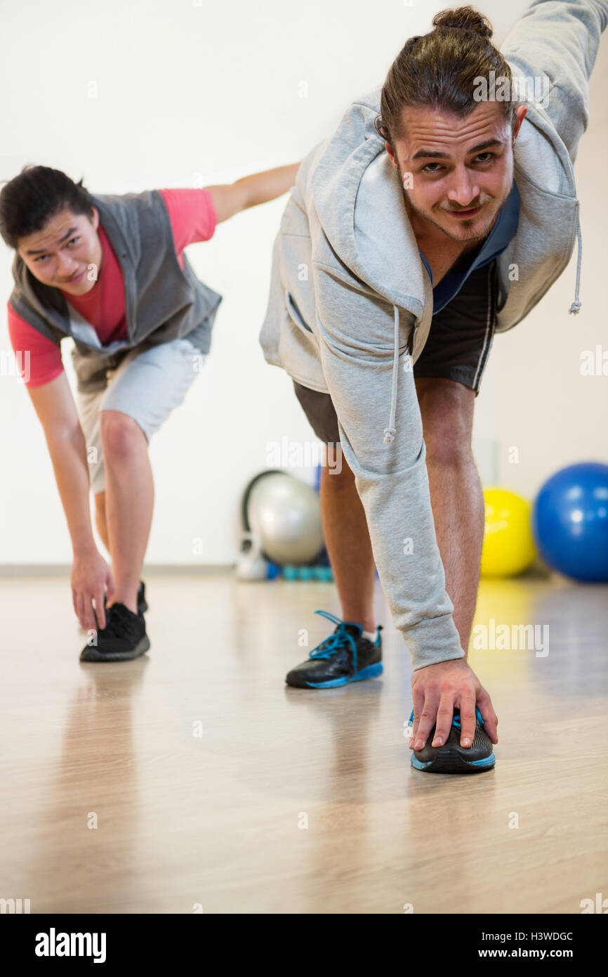 Men performing stretching exercise Stock Photo - Alamy