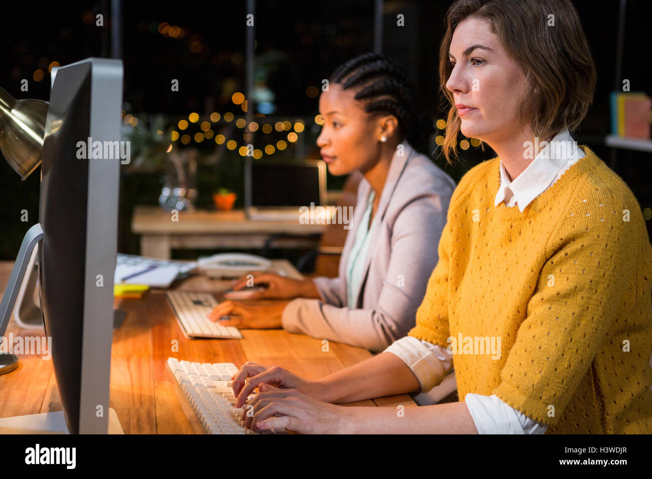 Businesswomen working on computer at their desk Stock Photo - Alamy
