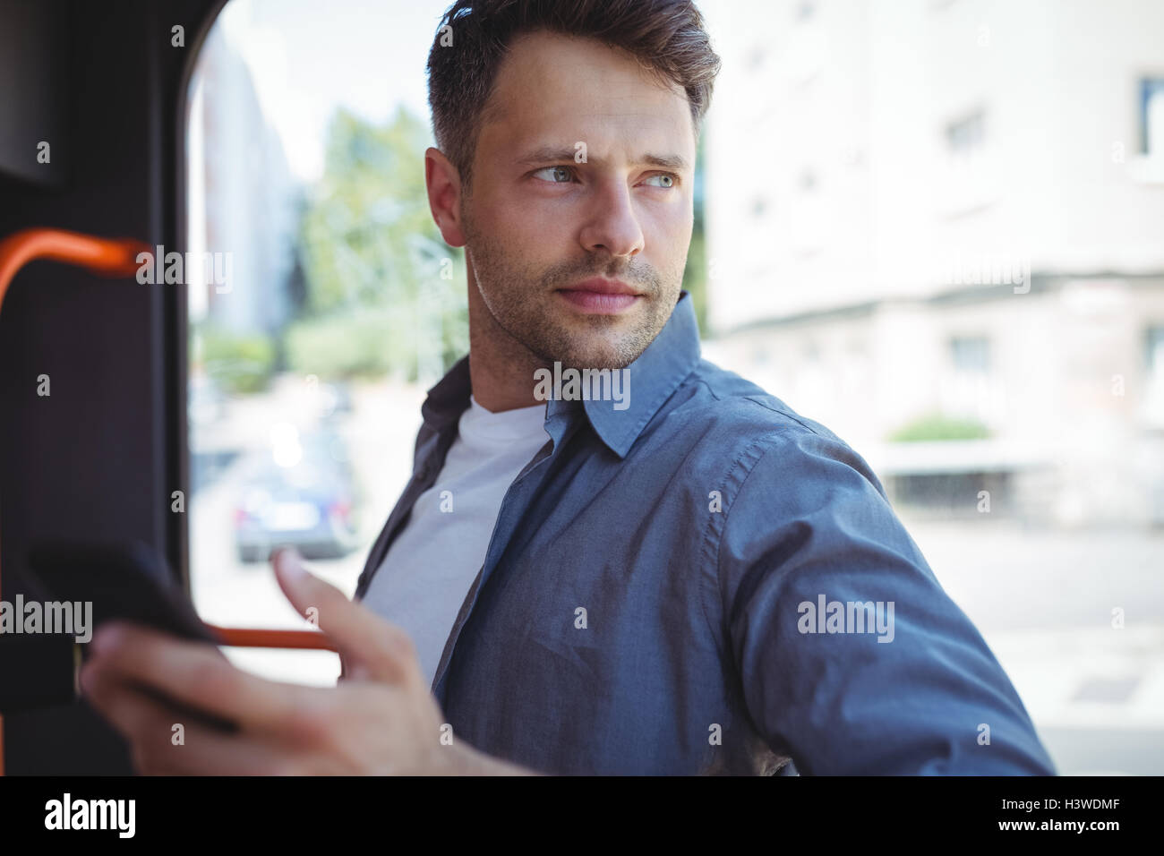 Handsome man travelling in bus Stock Photo - Alamy