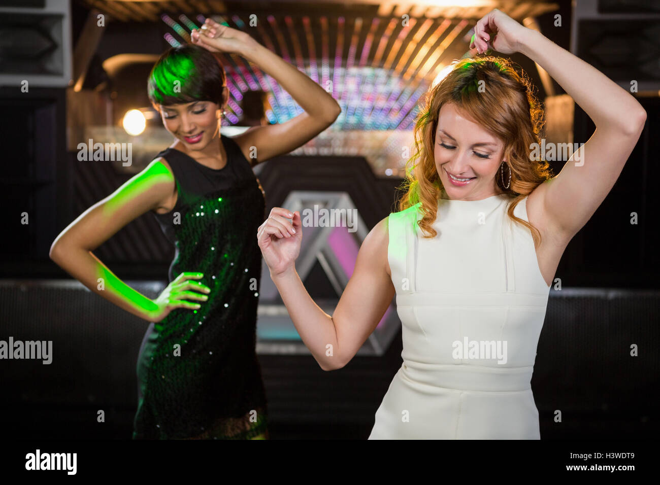 Smiling female friends dancing on dance floor Stock Photo - Alamy