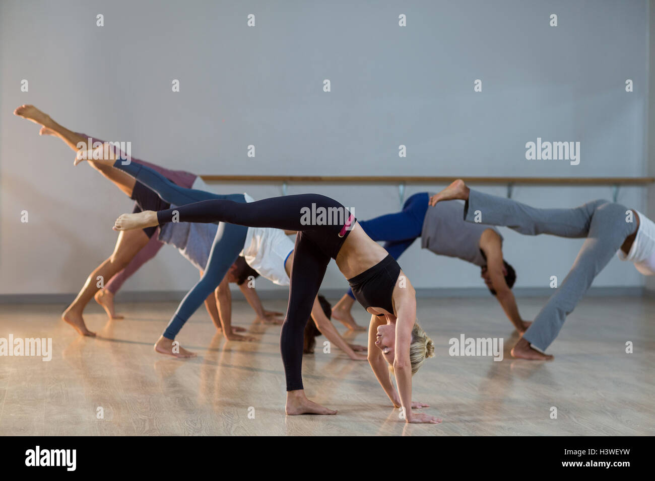 Group of people performing stretching exercise Stock Photo - Alamy