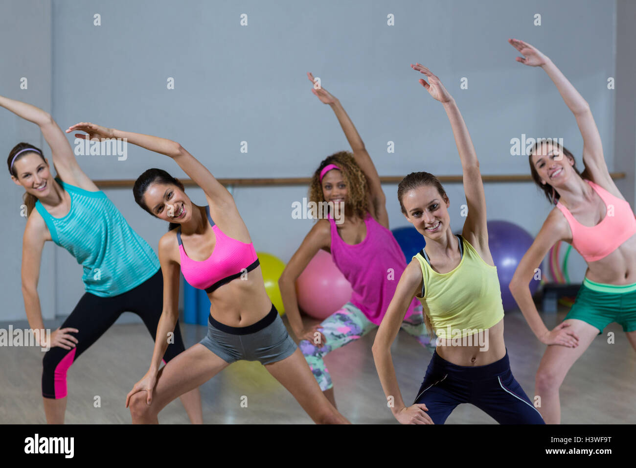 Group of fitness team performing stretching exercise Stock Photo - Alamy