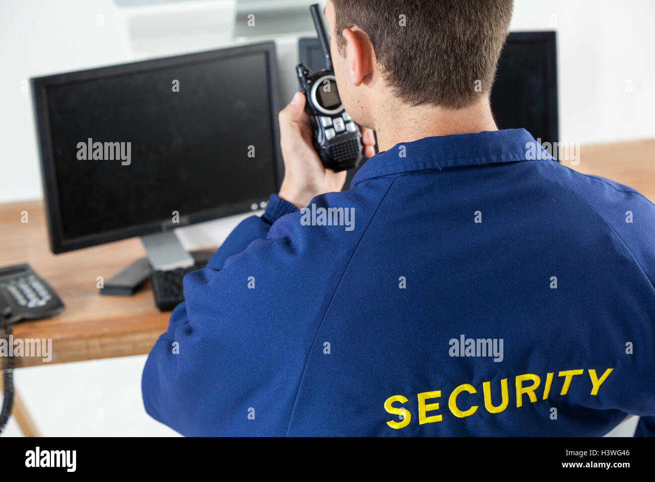 Security man looking at monitors hi-res stock photography and images ...