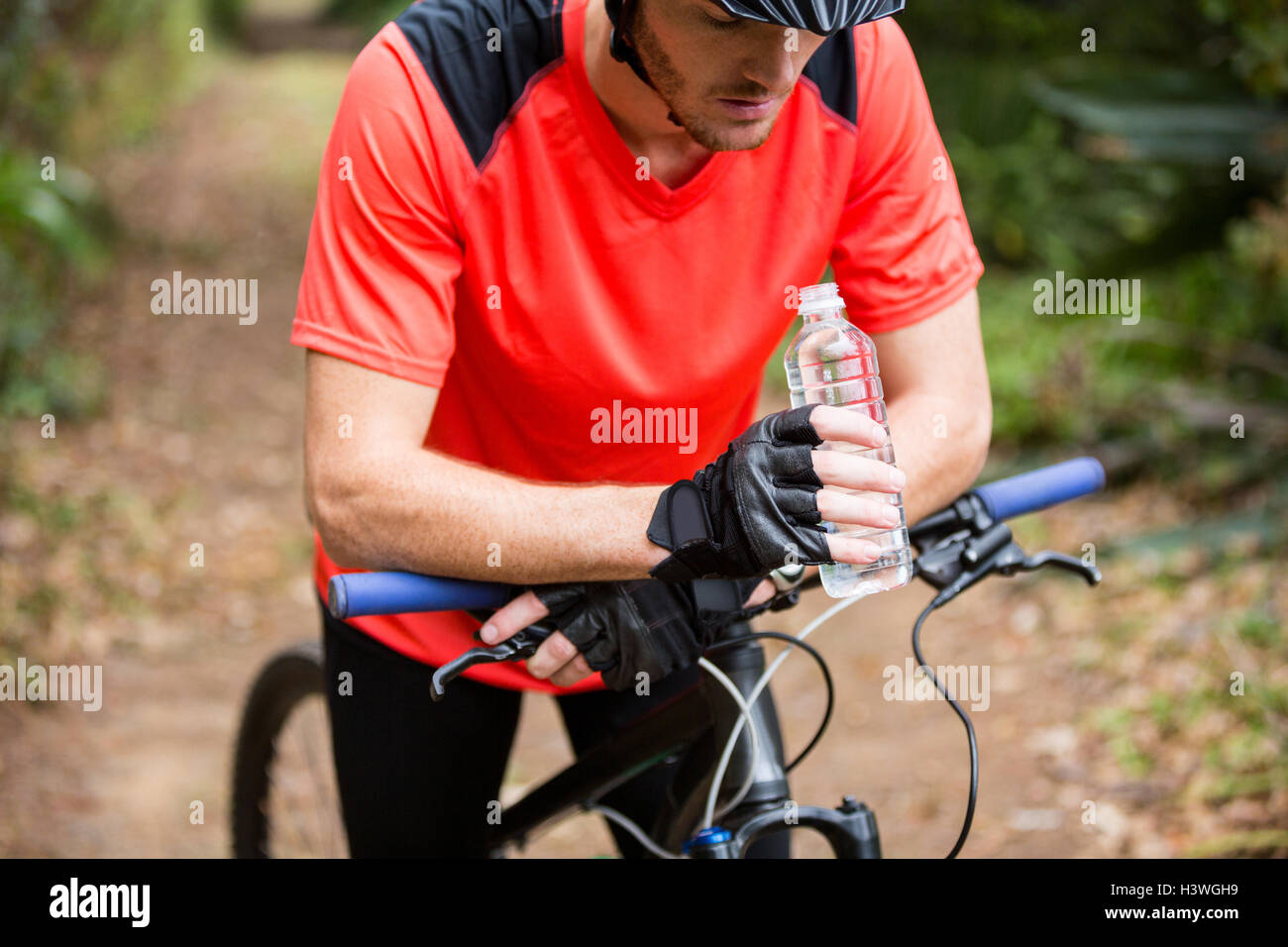 Male cyclist taking break during cycling Stock Photo - Alamy