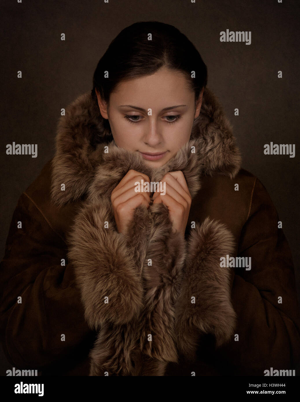 Portrait of a teenage girl in a fur coat Stock Photo - Alamy