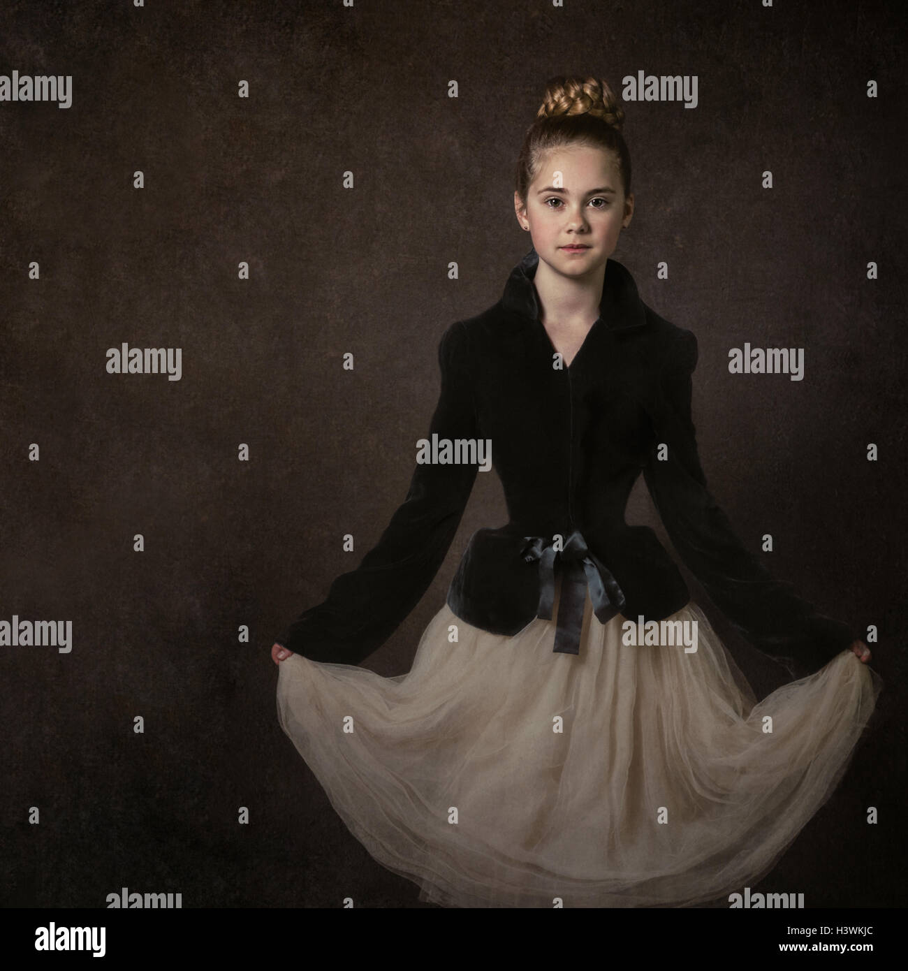 Portrait of a girl holding the hem of her dress Stock Photo - Alamy