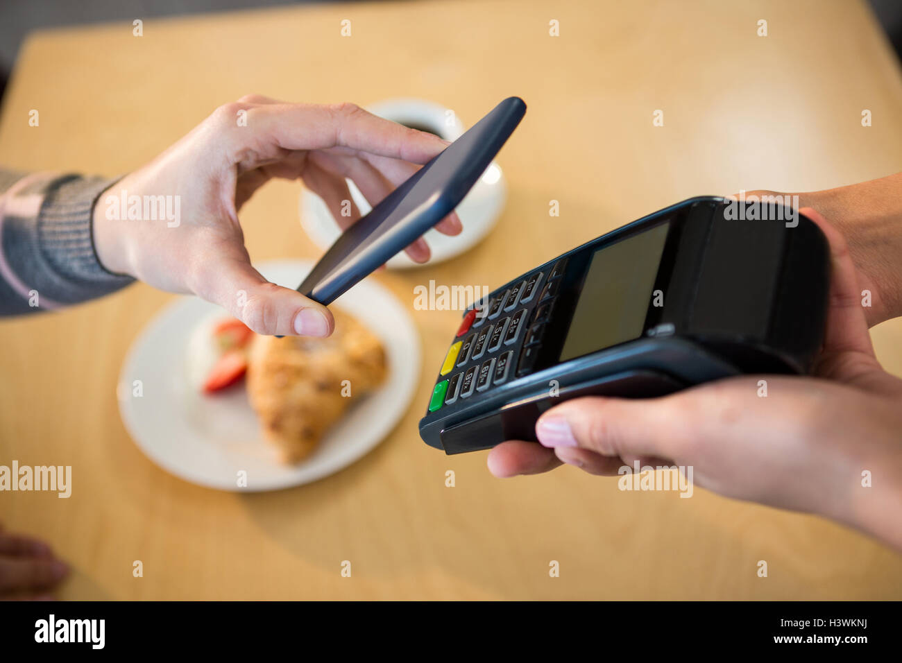 Woman making payment through smartphone Stock Photo - Alamy