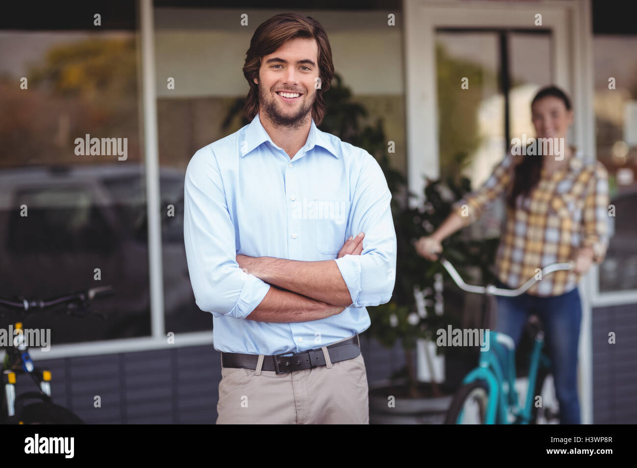 Portrait of man standing with arms crossed Stock Photo - Alamy