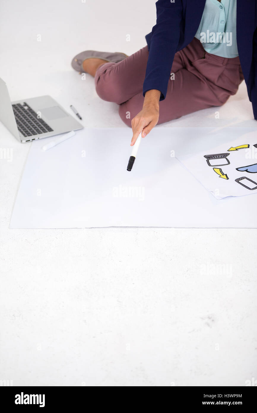 Businesswoman preparing a chart with icons Stock Photo - Alamy