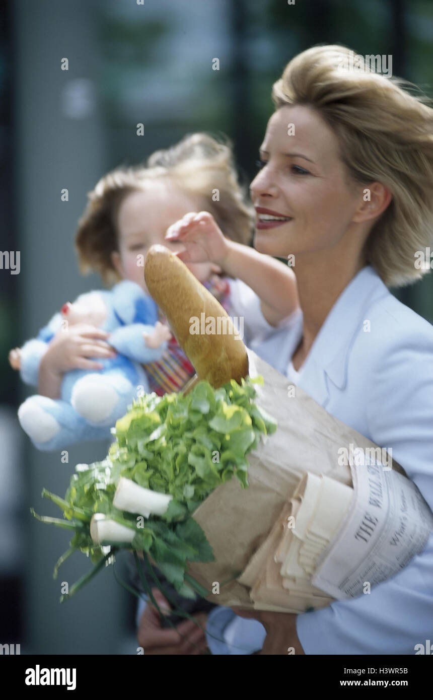 Businesswoman, happy, child, purchasing, carries, side view, half ...