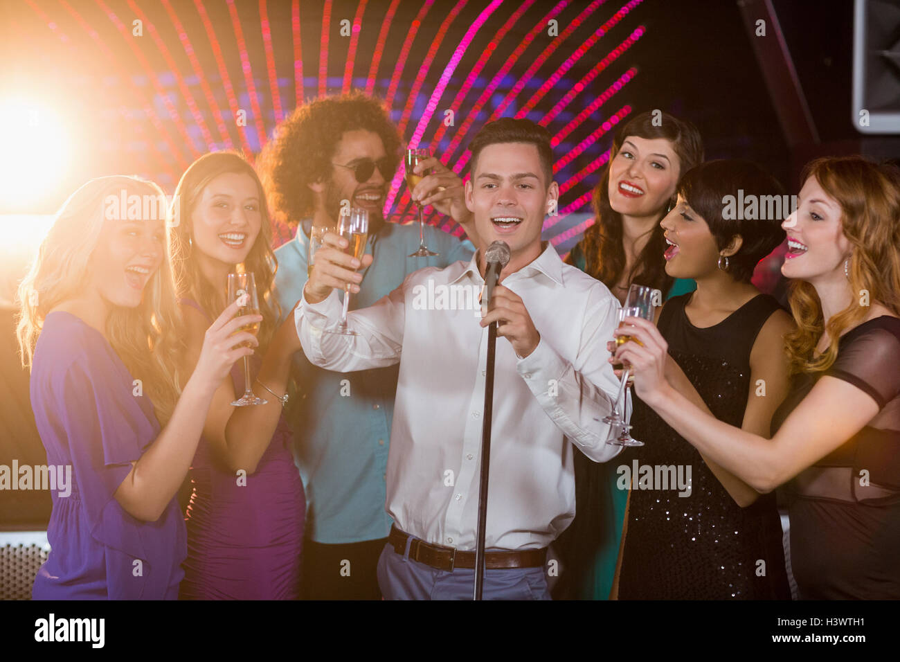 Group of friends singing song together in bar Stock Photo - Alamy
