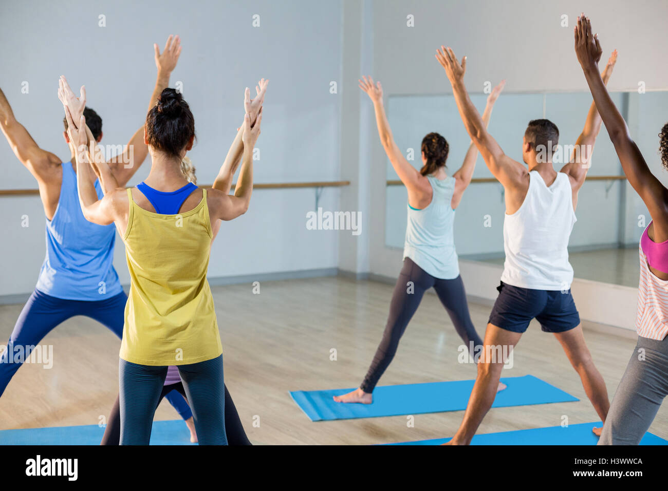 Yoga instructor helping student with a correct pose Stock Photo - Alamy