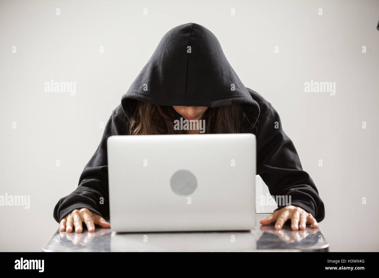 Hacker using a laptop Stock Photo - Alamy