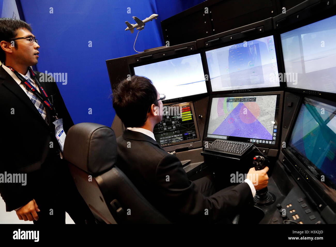 Tokyo, Japan. 12th October, 2016. A man operates an Unmanned Aerial ...