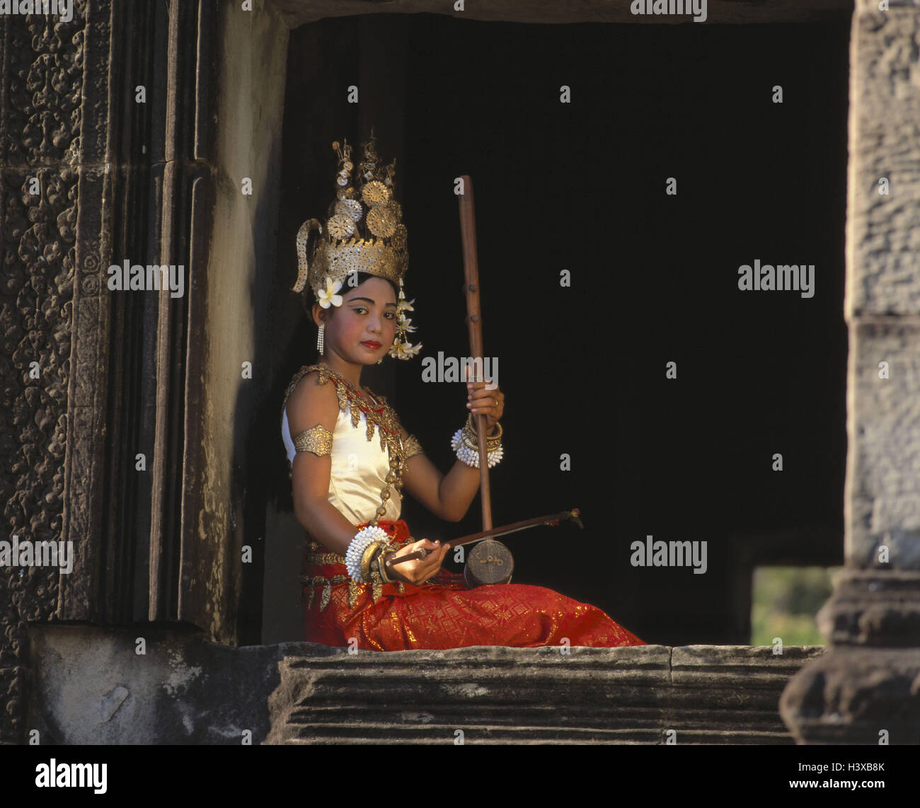 Cambodia, Angkor Wat, woman in traditional clothes, sits at the input ...