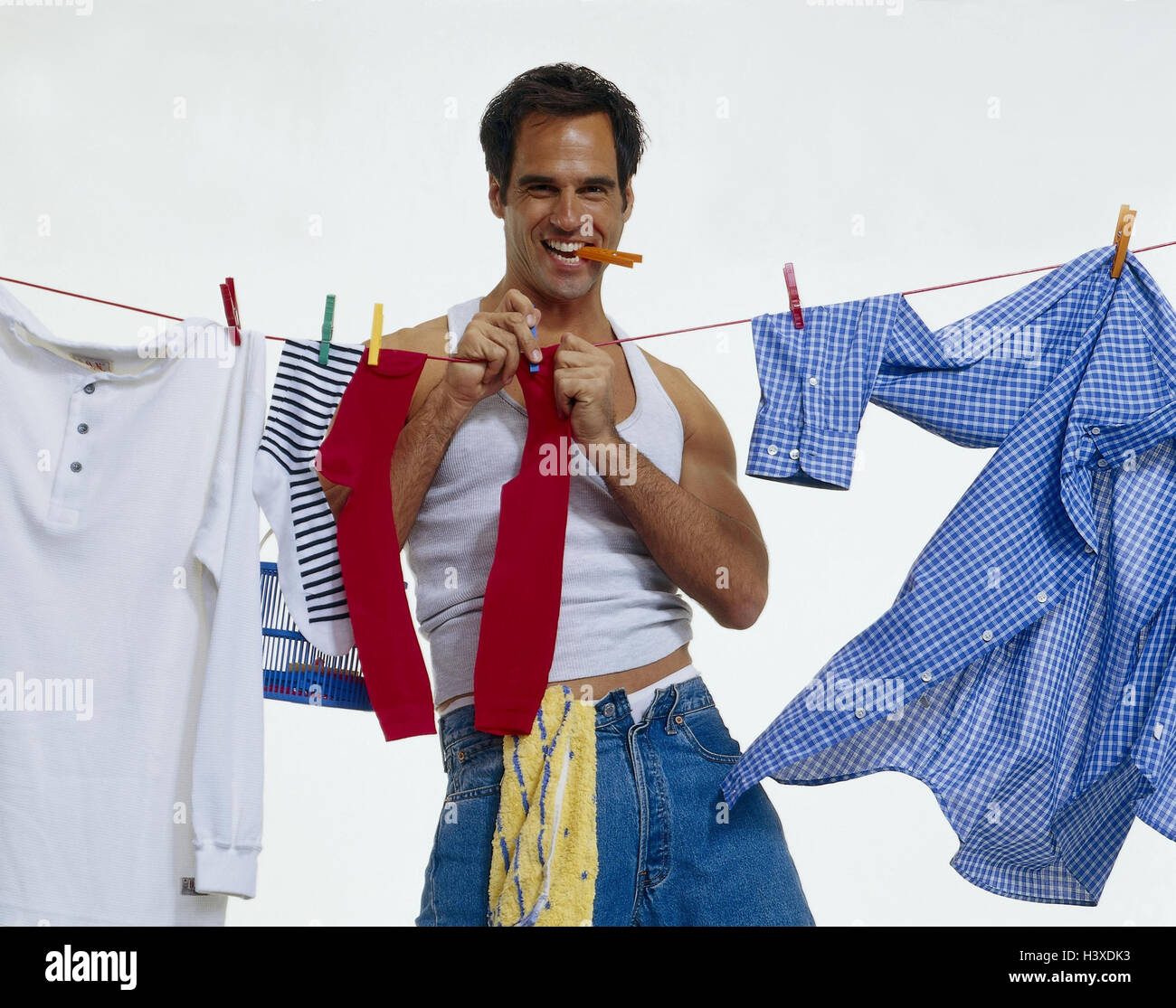 Man, young, clothesline, laundry, hang up men, inside, studio, cut out ...