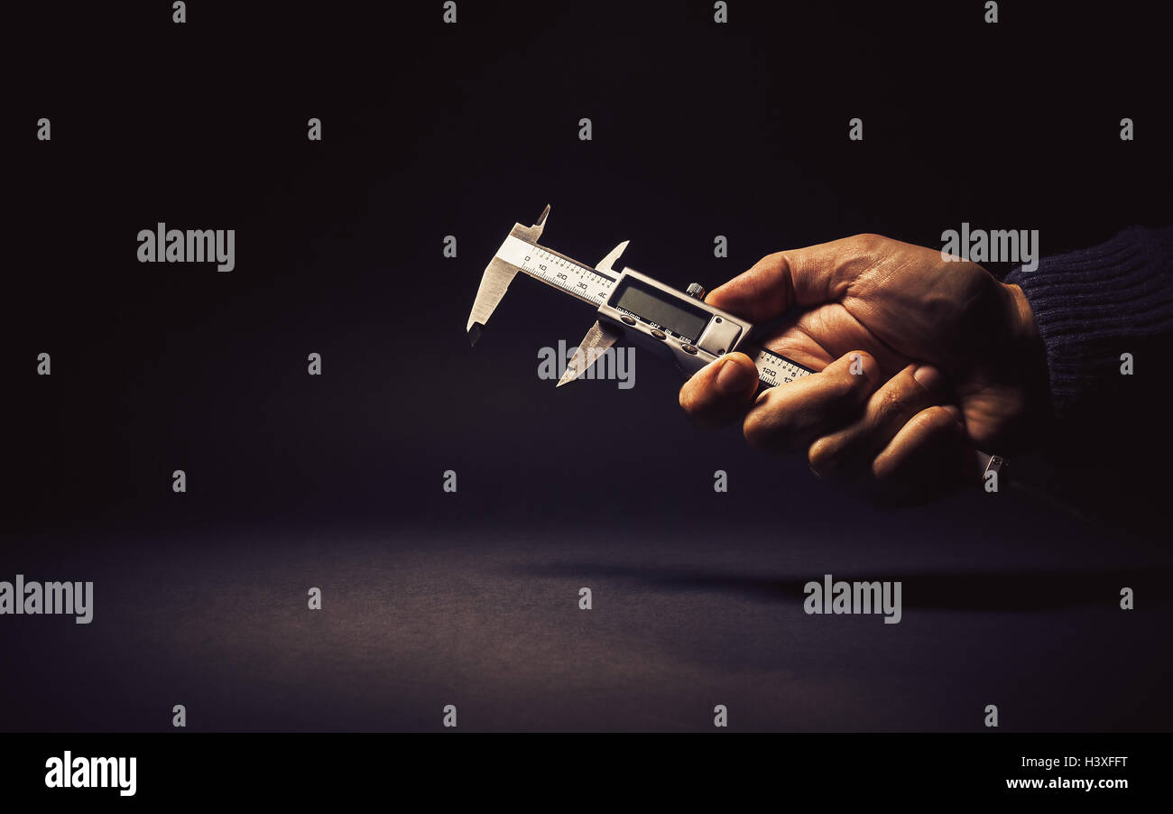 Vernier caliper in male hand, conceptual composition about precise ...