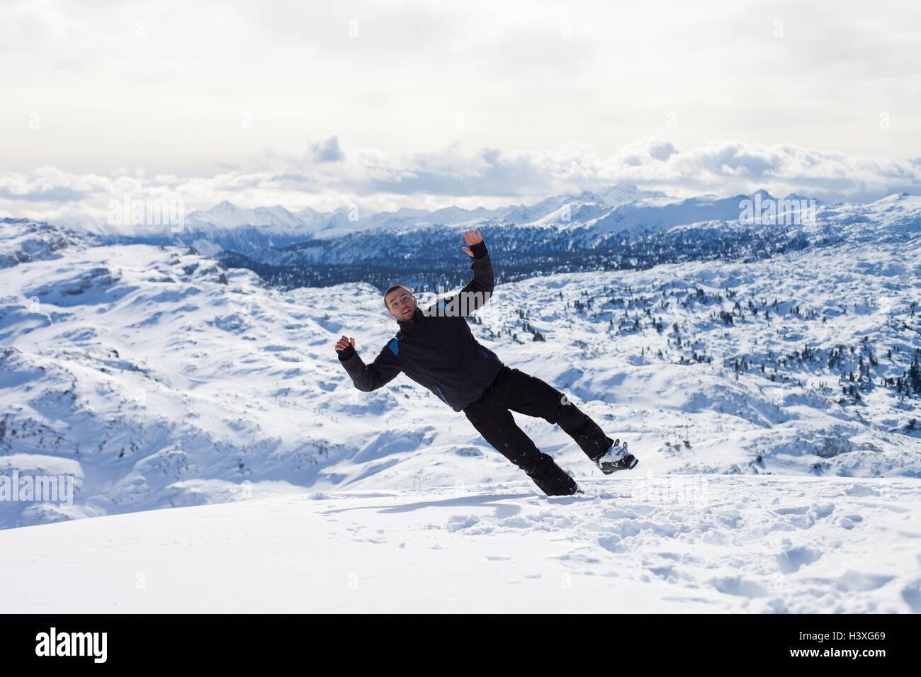 Young skier, enjoying the view from top of mountains in Austrian ski ...