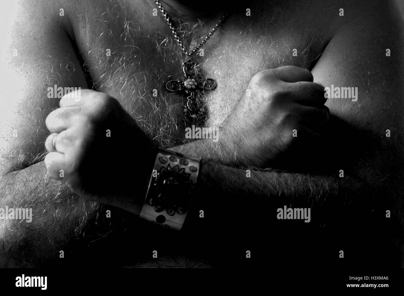 Man, free upper part of the body, detail, arms crossed, fists, b/w ...