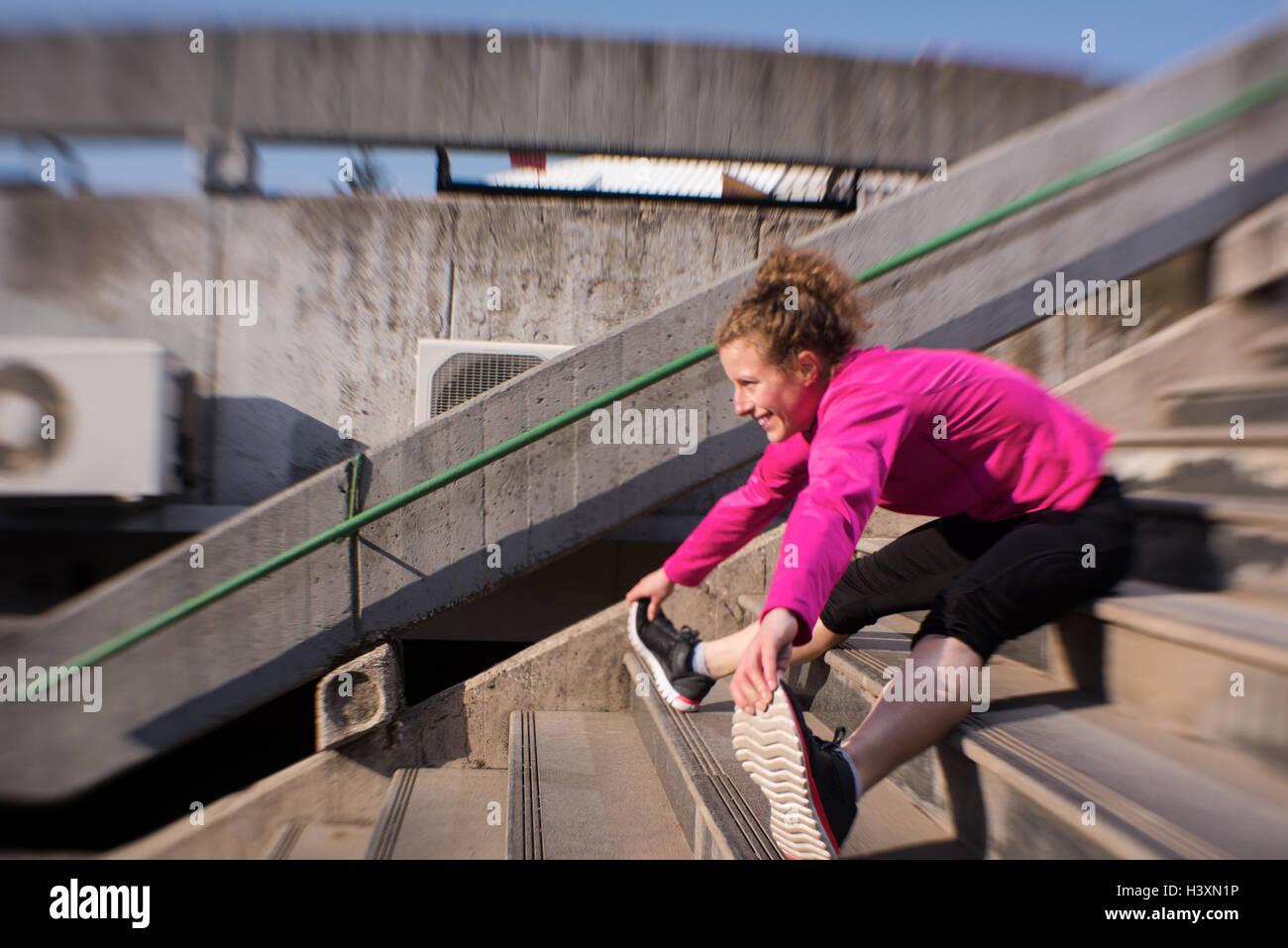runner woman warming up and stretching before morning jogging Stock ...