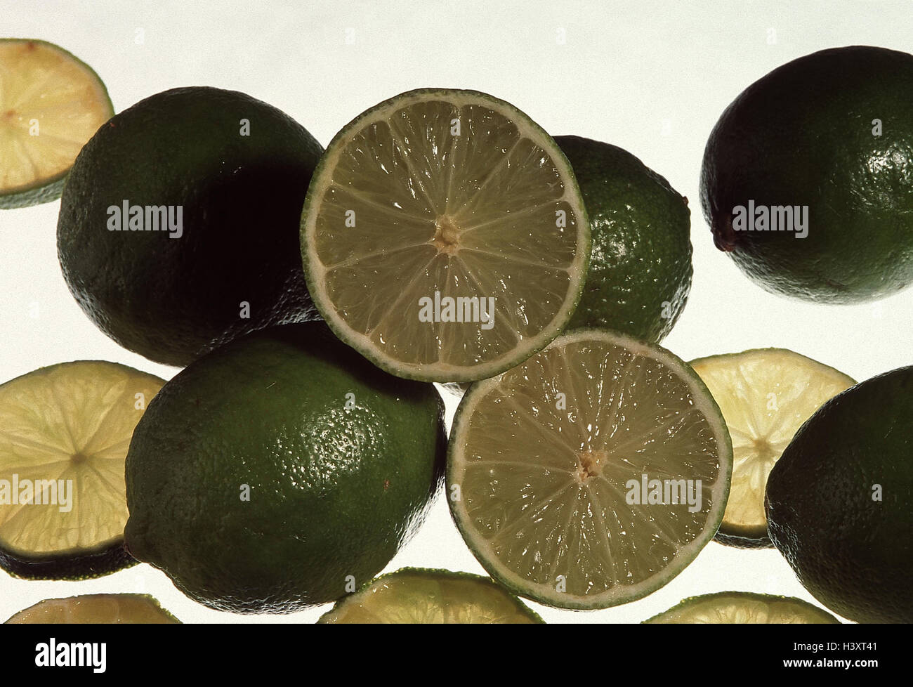 Limes, completely, halves, Still life, cut out, citrus fruit, citrus ...