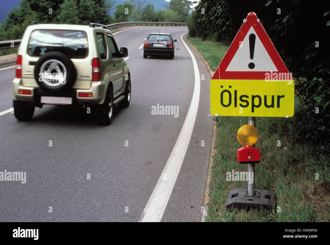 Oil on road car registration number make unrecognizable traffic sign hi ...