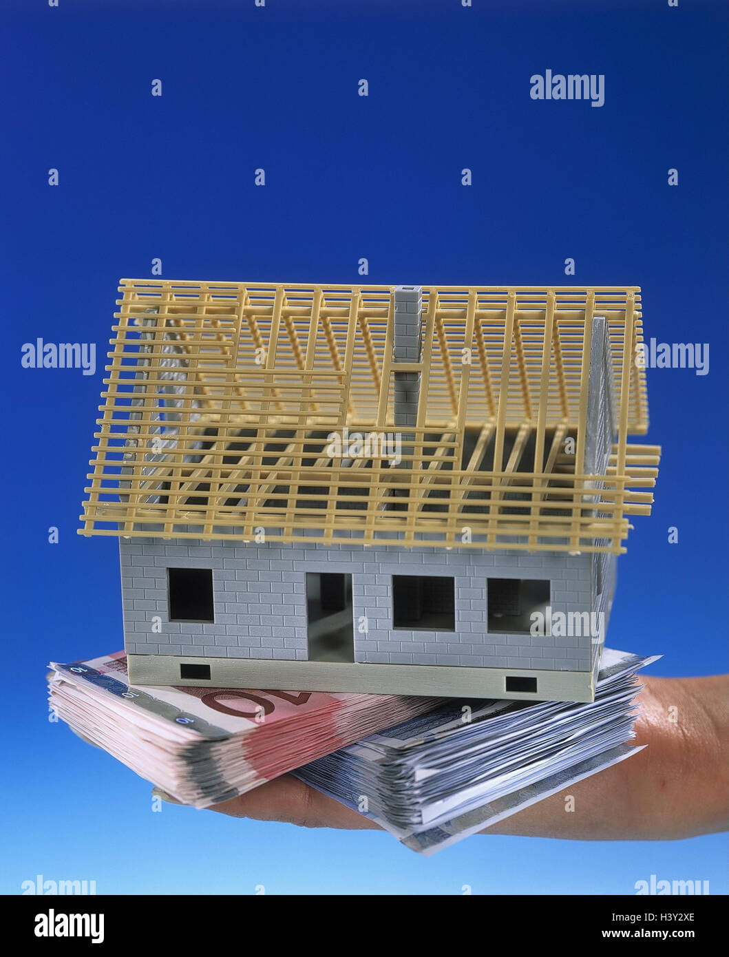 Women's hand, icon, building of a house, financing, bank notes, euro ...